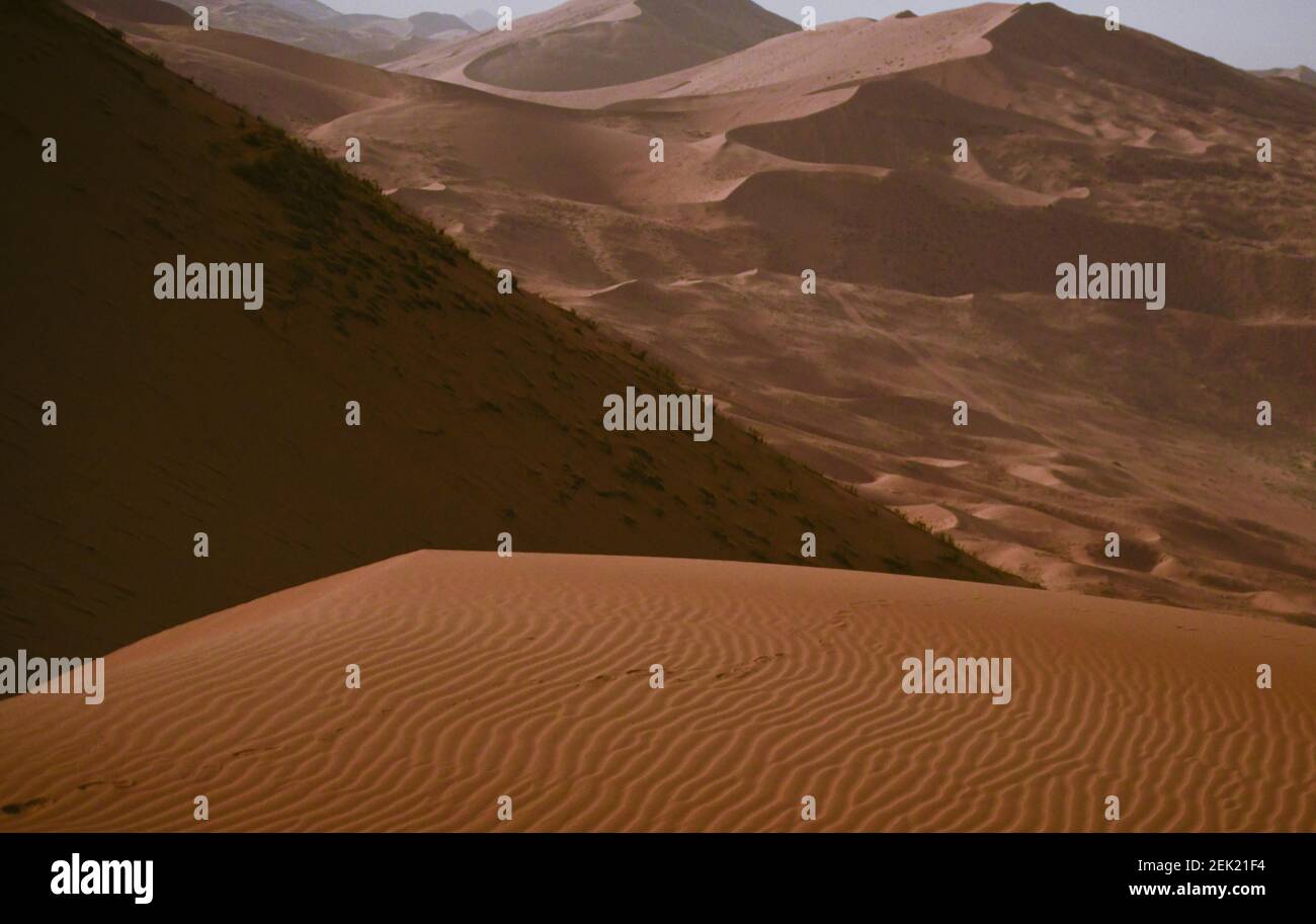 An aerial view of sunshine of the setting sun on the sand hills in the ...