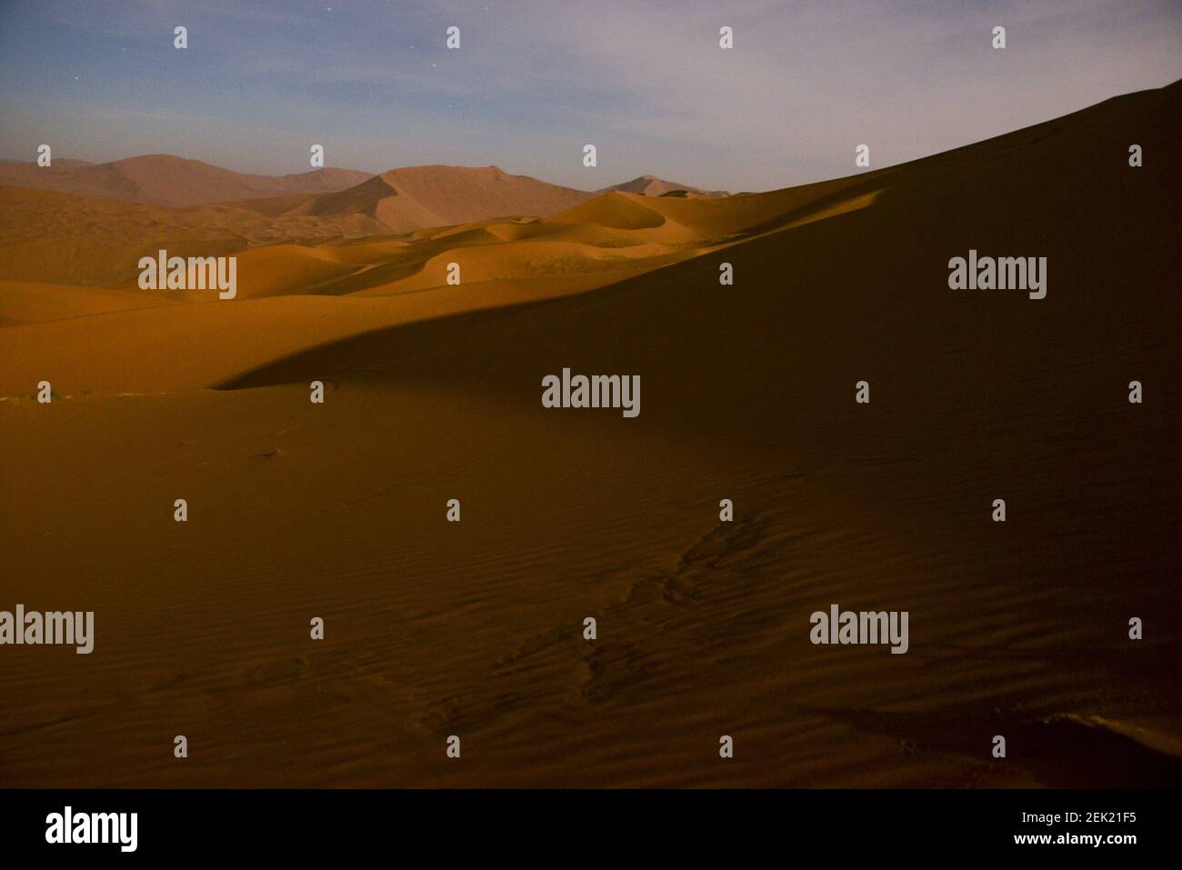 An aerial view of sunshine of the setting sun on the sand hills in the ...