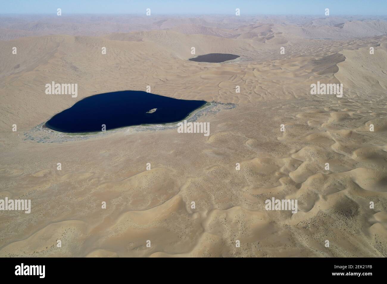 An aerial view of small lakes scattering in the Badain Jaran Desert ...