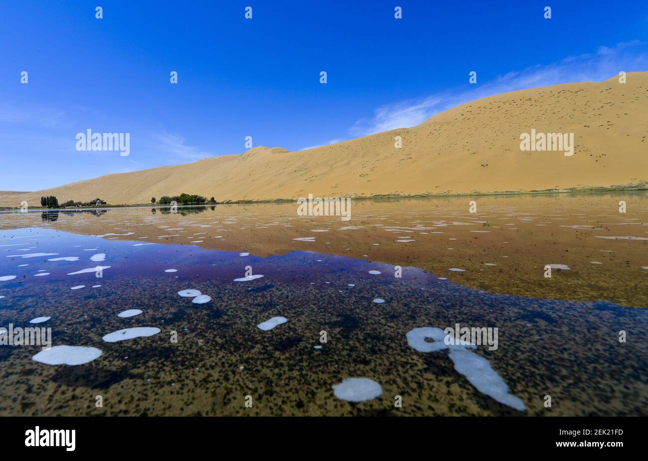 An aerial view of small lakes scattering in the Badain Jaran Desert ...