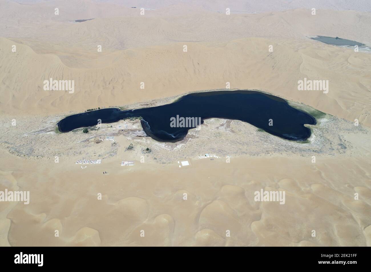 An aerial view of small lakes scattering in the Badain Jaran Desert ...