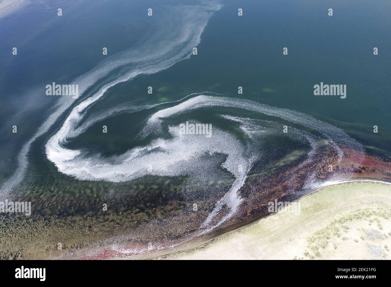 An aerial view of small lakes scattering in the Badain Jaran Desert ...