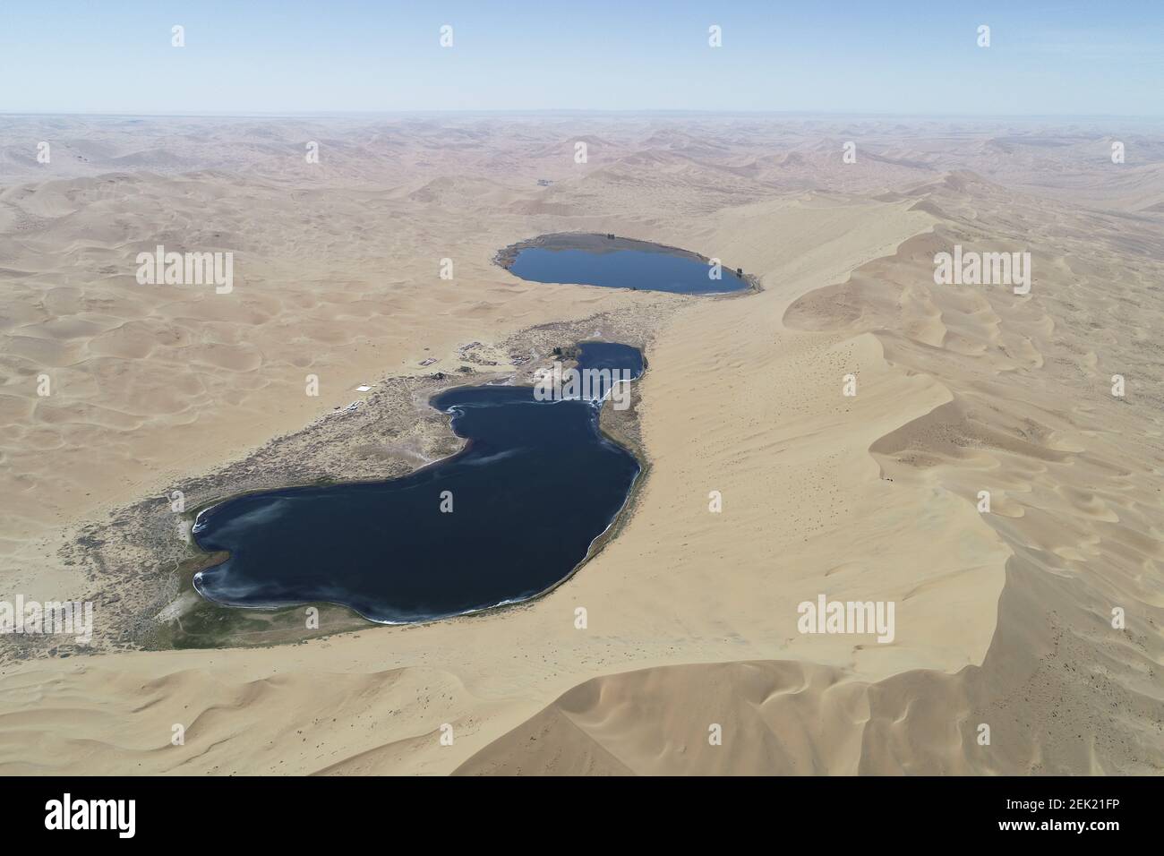 An aerial view of small lakes scattering in the Badain Jaran Desert ...