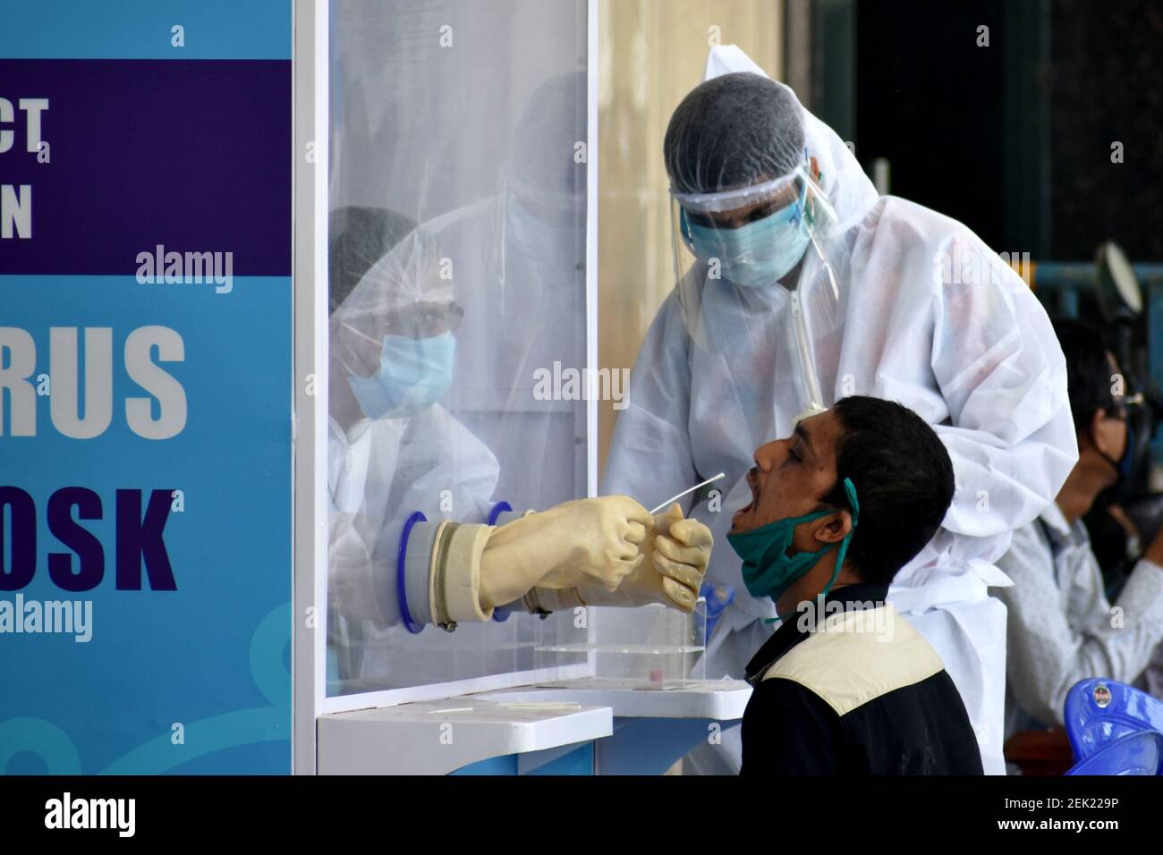 People line-up and take swab tests at a Covid-19 testing site in Howrah ...