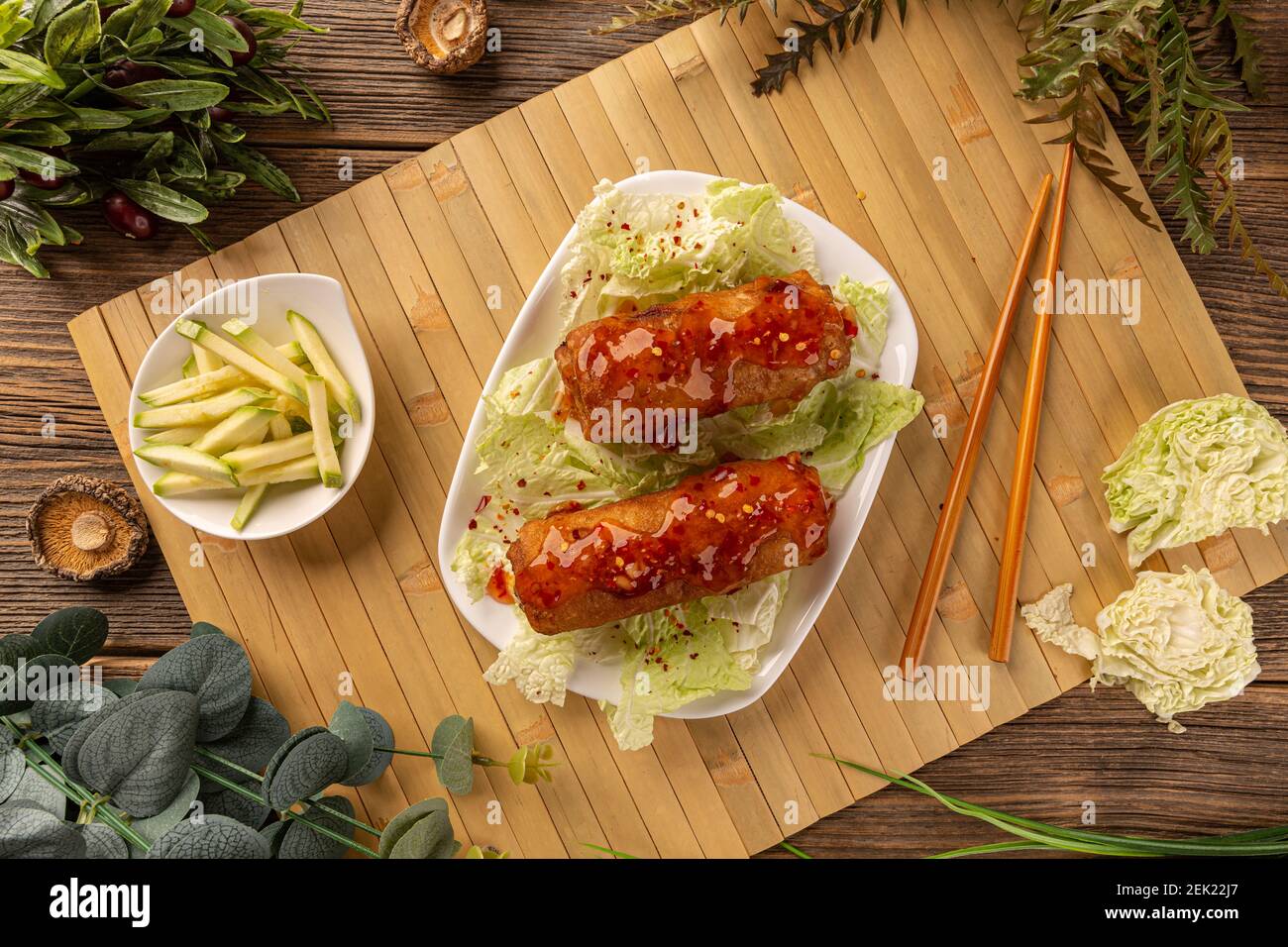 Spring roll with meat filling with chili sauce topping Stock Photo - Alamy