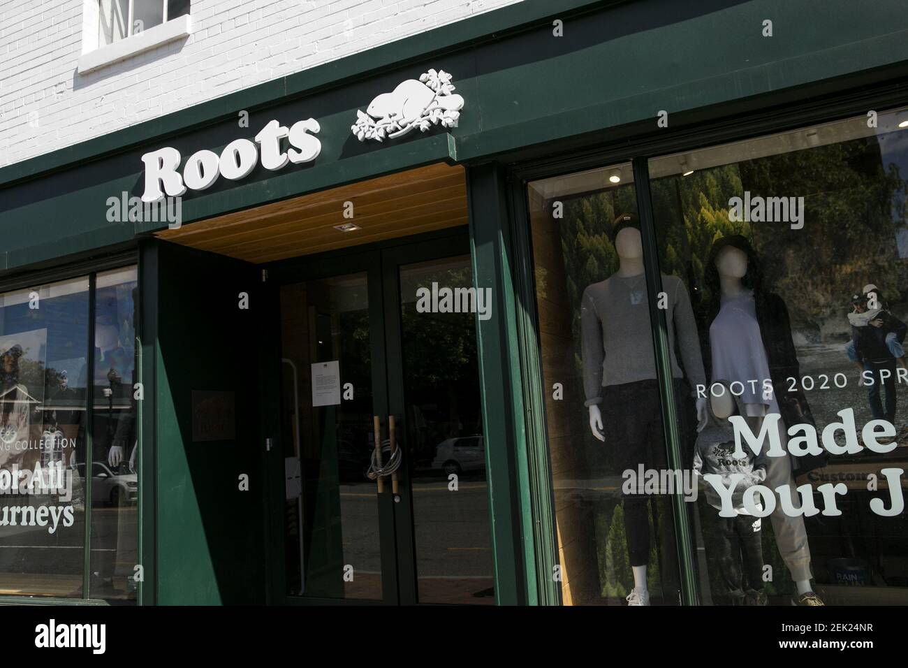 A logo sign outside of a Roots retail store location in Washington, D.C ...