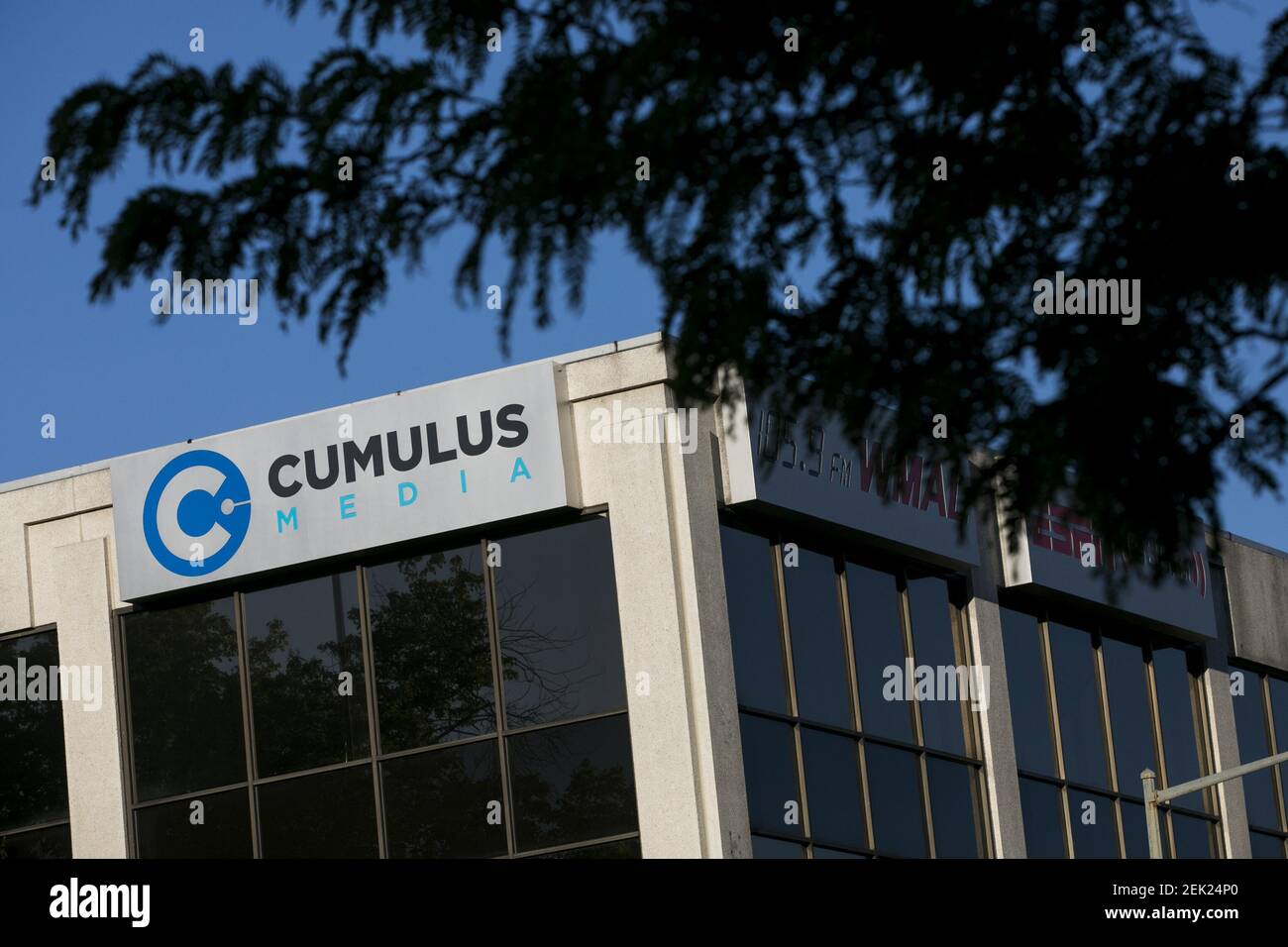 A logo sign outside of a facility occupied by Cumulus Media in ...