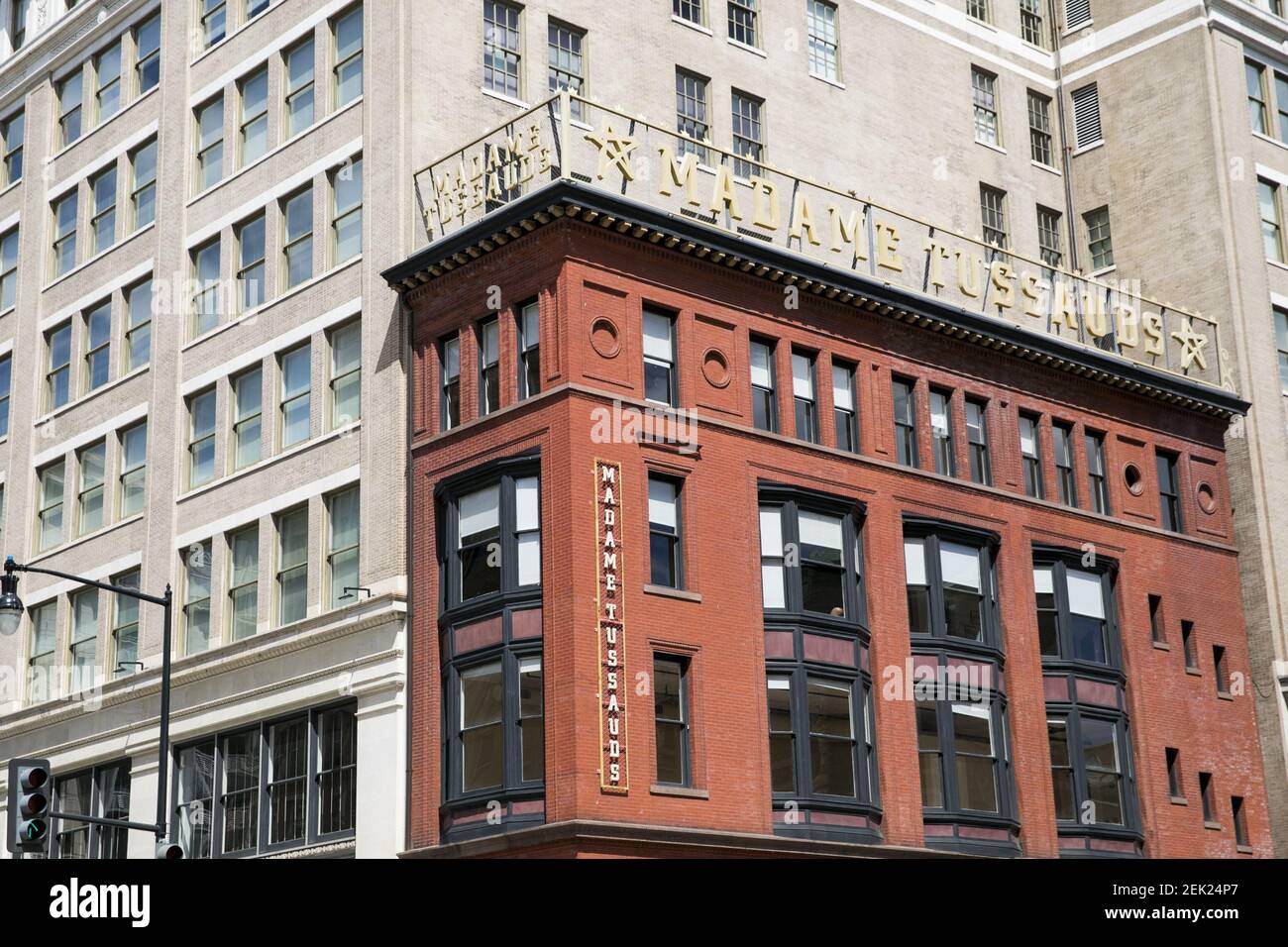A logo sign outside of a Madame Tussauds wax museum location in ...