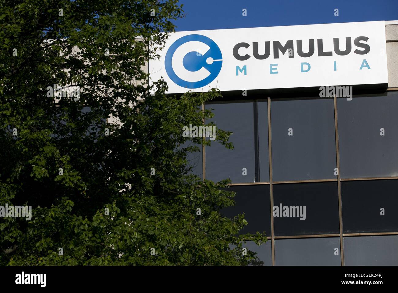 A logo sign outside of a facility occupied by Cumulus Media in ...