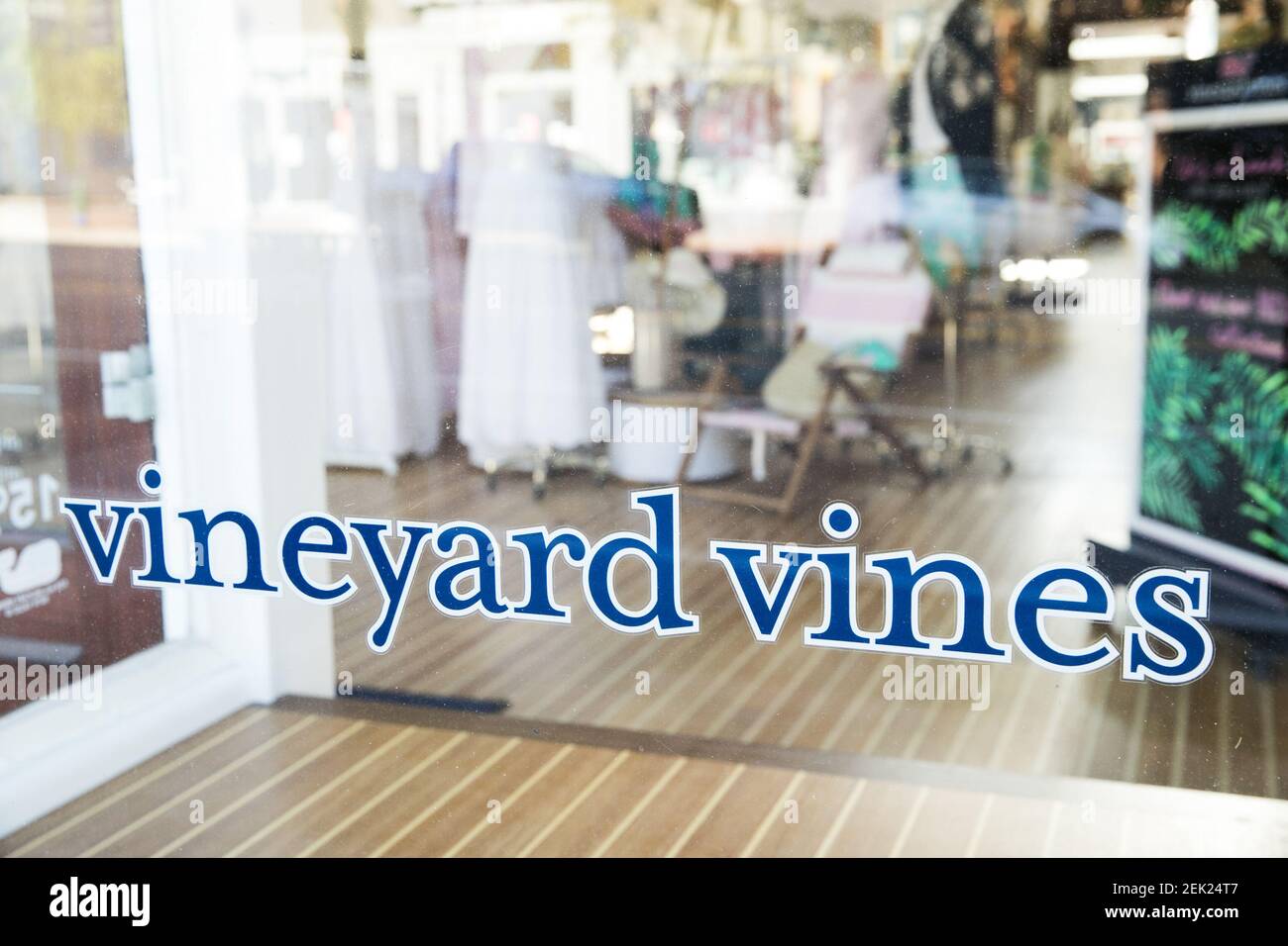 A logo sign outside of a Vineyard Vines retail store location in ...