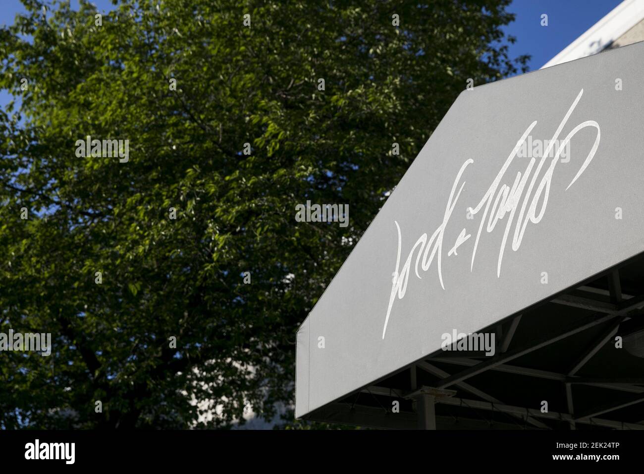 A logo sign outside of a Lord & Taylor retail store location in ...