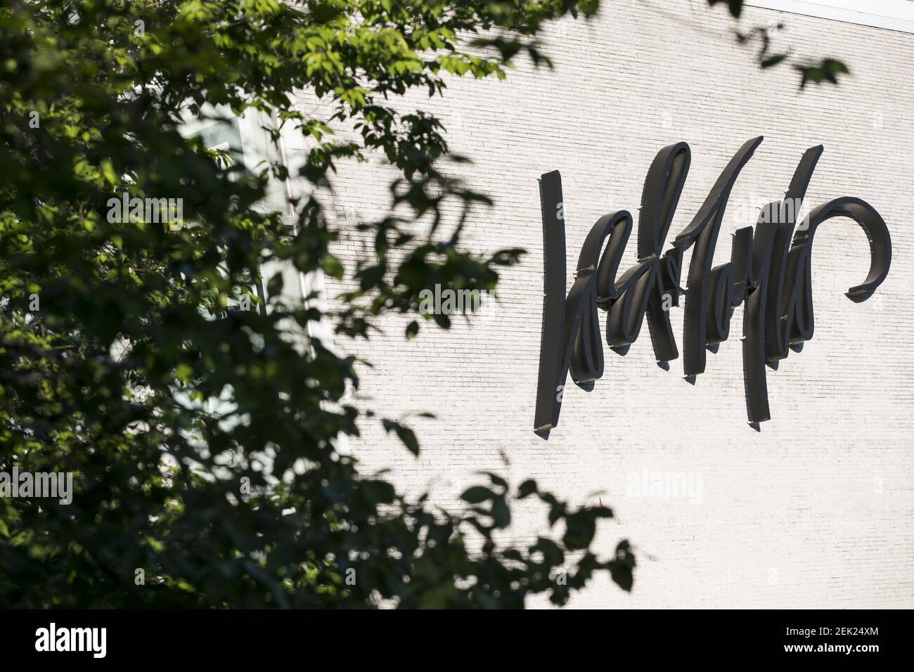 A logo sign outside of a Lord & Taylor retail store location in ...