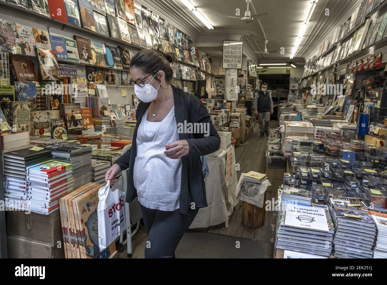 A customer seen exiting the Stock bookstore after making some purchases ...