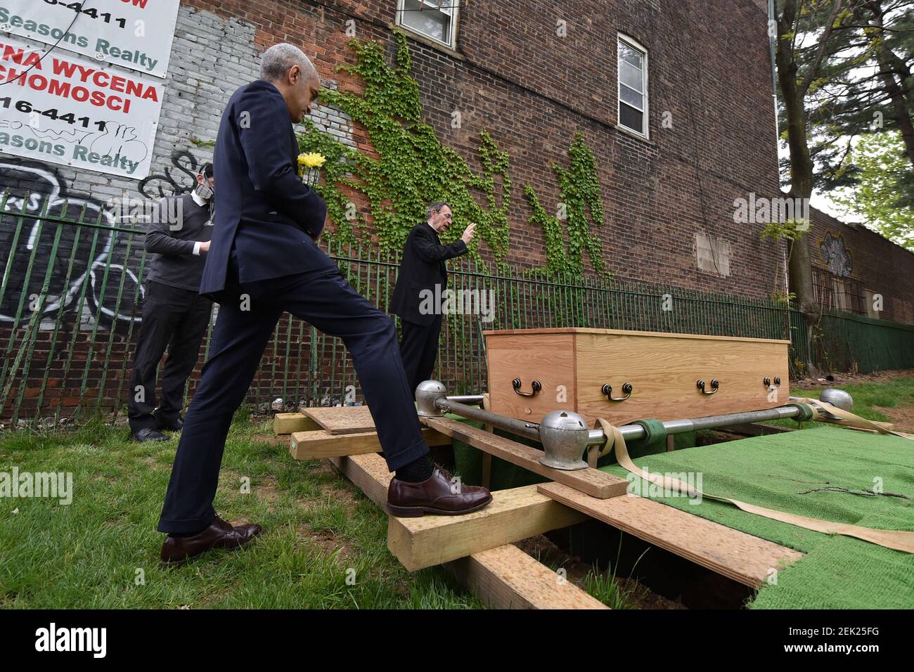 Funeral Director Omar Rodriguez stands in front of his father’s casket ...