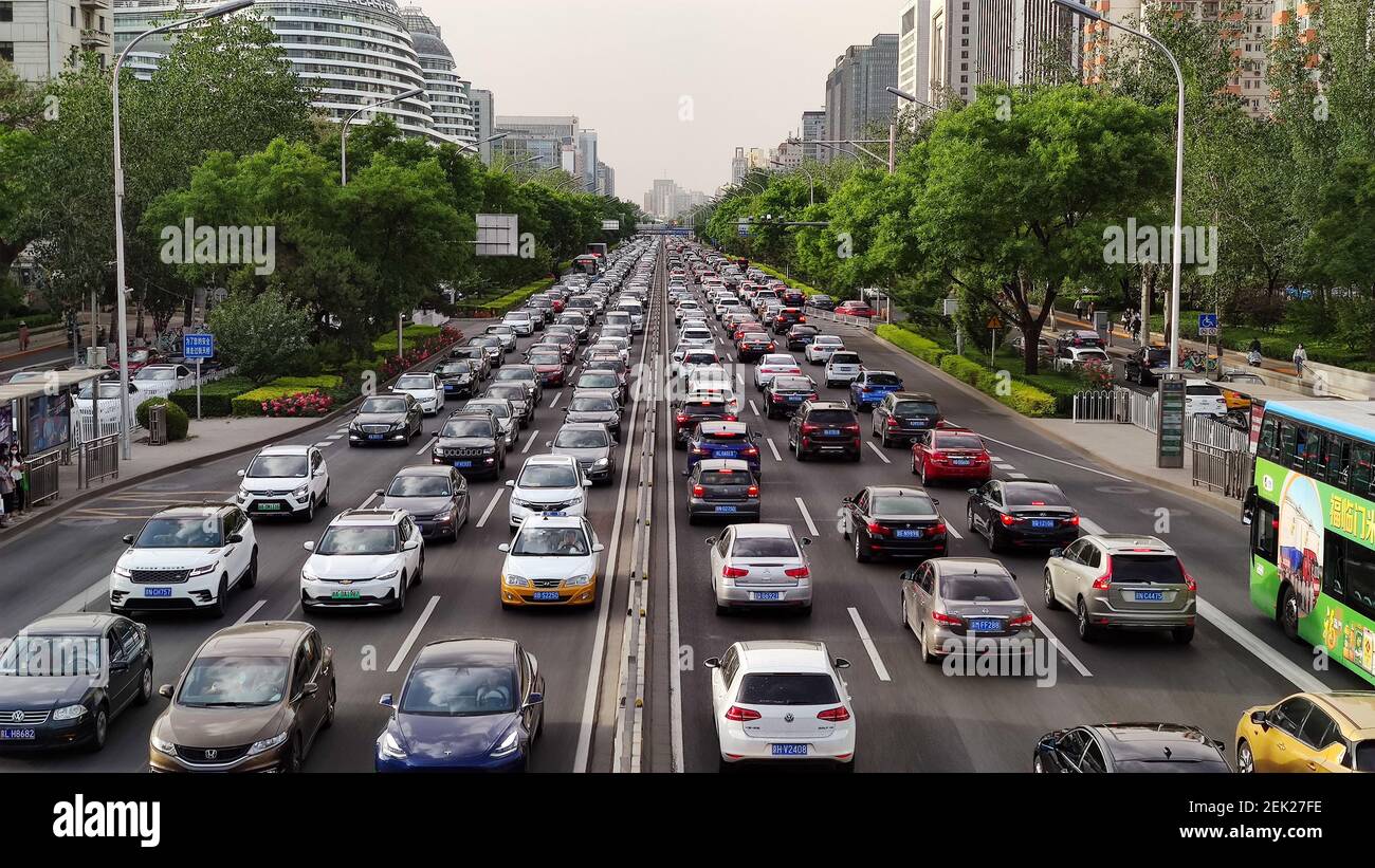 Traffic stream composed of various vehicles moves slowly during the ...