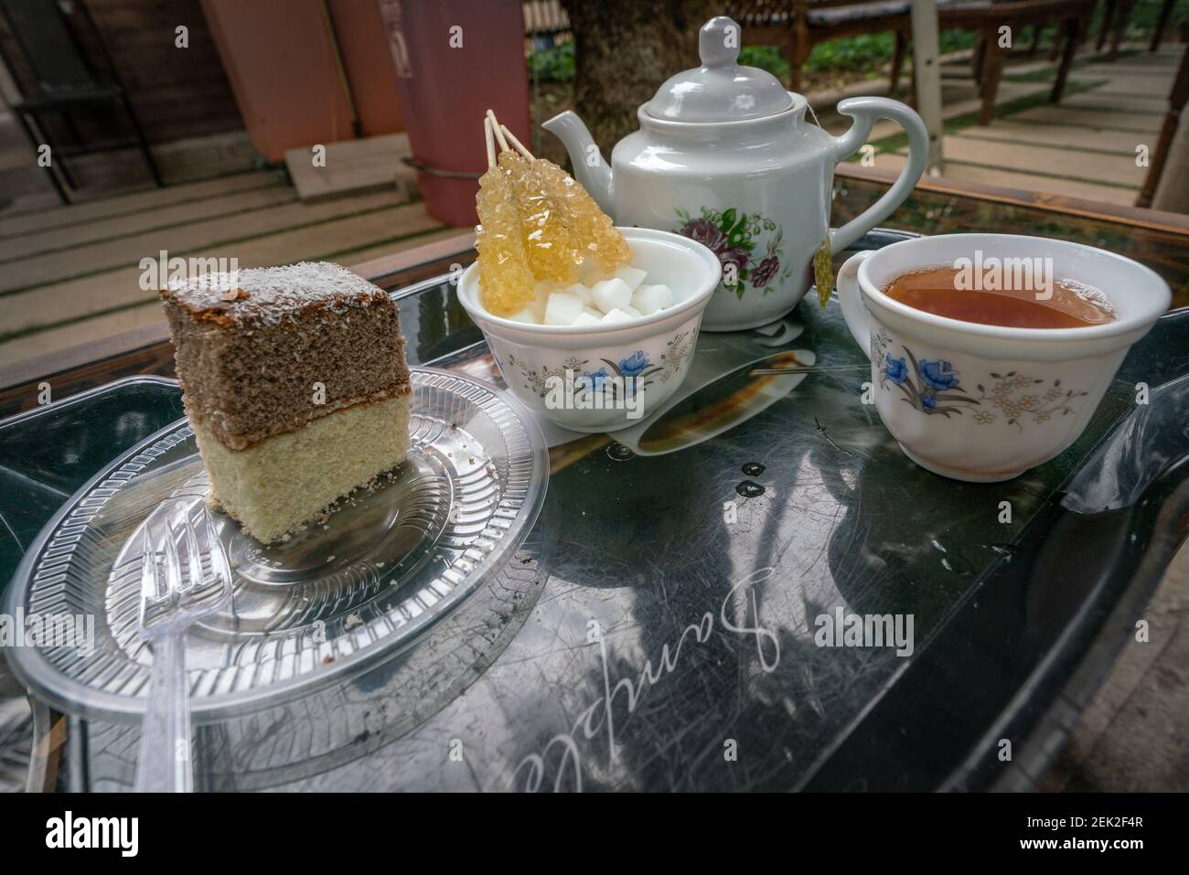 Iranian tea set with cake and saffron rock sugar. Traditional tea in a ...