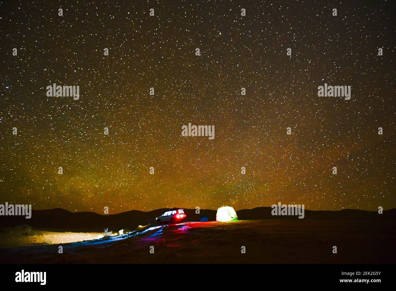 ALXA LEAGUE, CHINA - MAY 12, 2020 - A tourist watches the stars in the ...