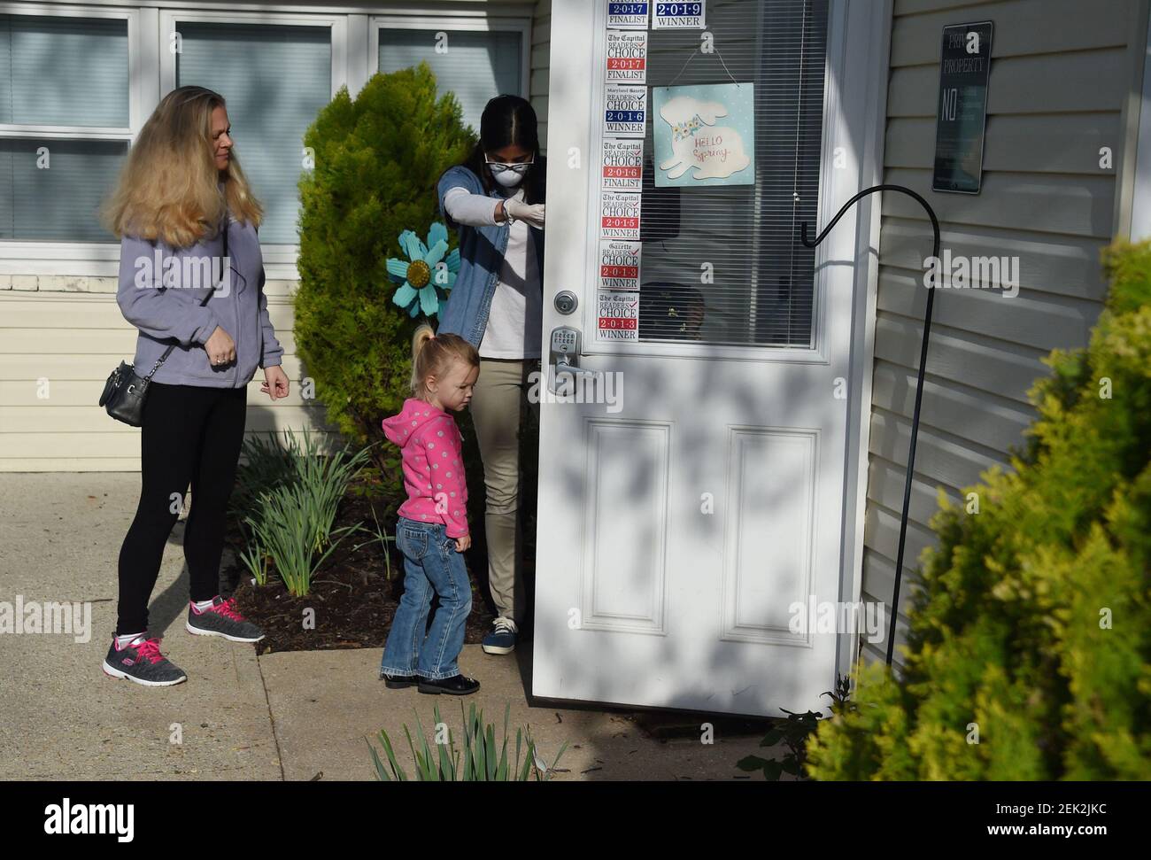 Nerrys Cancel, lead teacher, holds the door as Sarah Wehner watches as ...