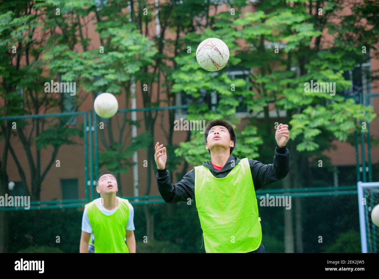 Students play football at a football class at Rugao Foreign Language ...
