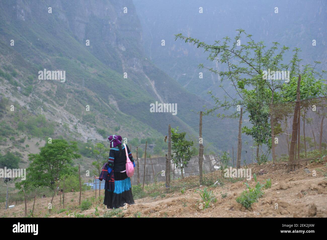 Villagers take their luggage, step outside the cliff village via the ...