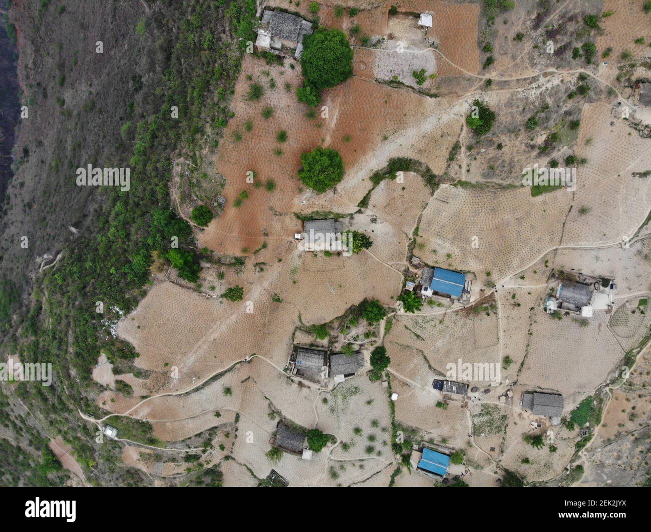 An aerial view of houses scattering on a cliff, where the cliff village ...