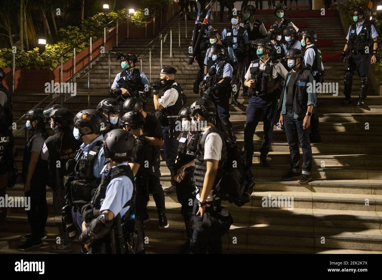 Riot police officers stand on guard outside the New Town Plaza shopping ...