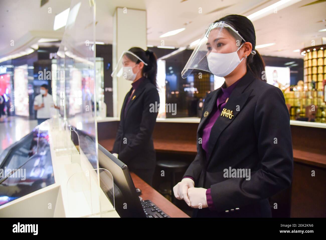 Staffs members of Siam Paragon shopping wearing face shields as a ...