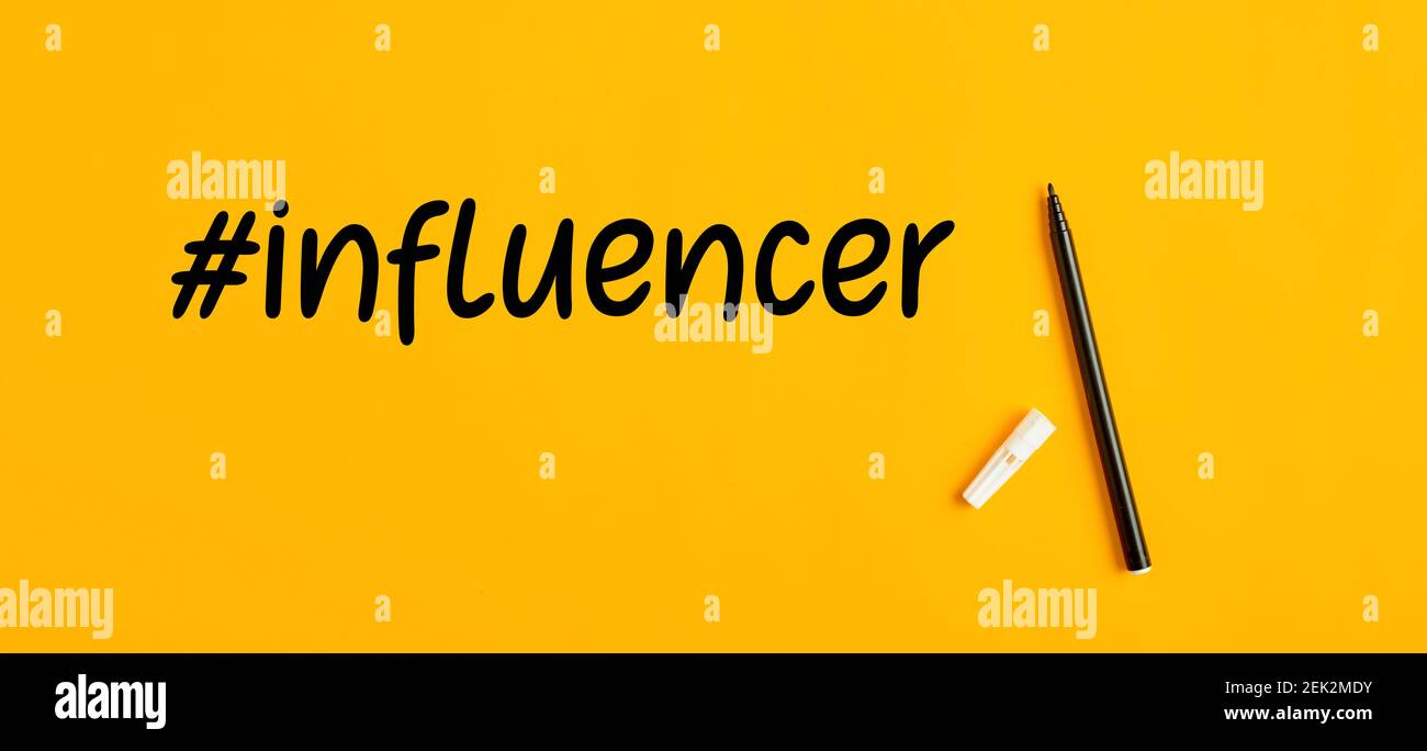 Hand written influencer word with hashtag symbol and a pen marker on ...