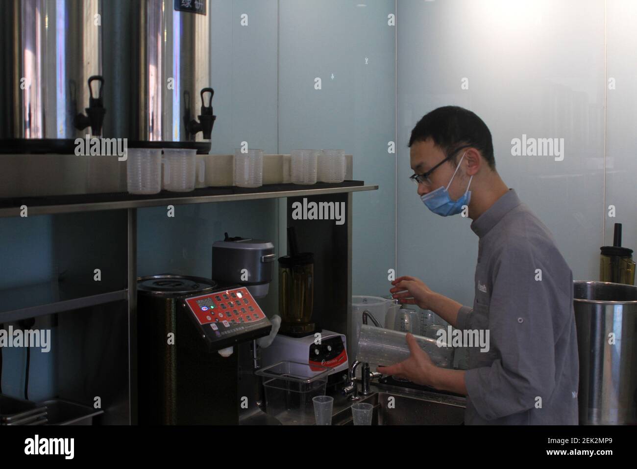 A staff is making milk tea at a Wahaha milk tea store in Huai'an city ...