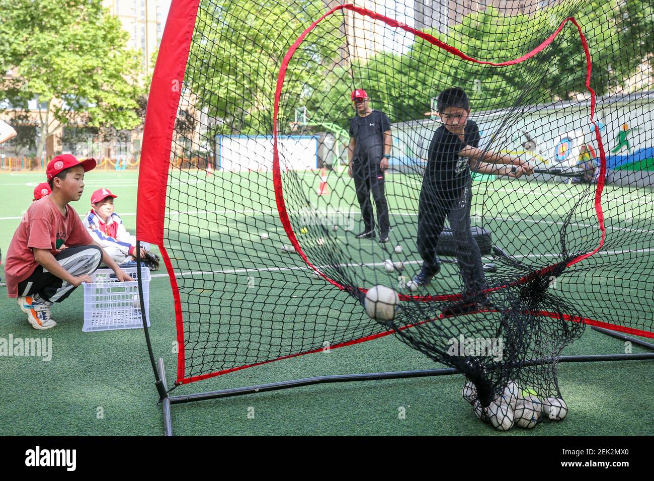Students play baseball at a sports class at Nanjiangcun Elementary ...