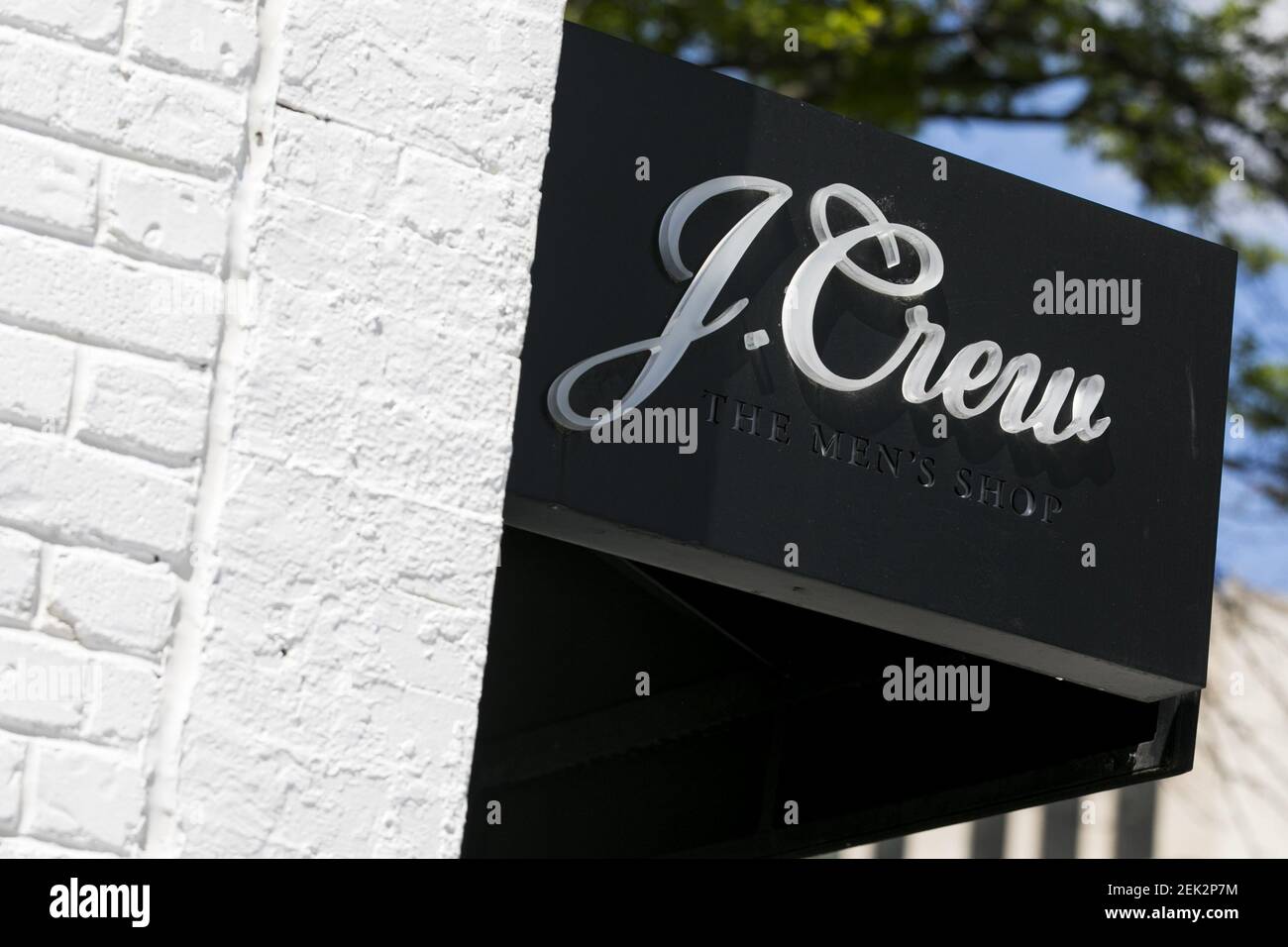 A logo sign outside of a J.Crew The Men's Shop retail store location in ...
