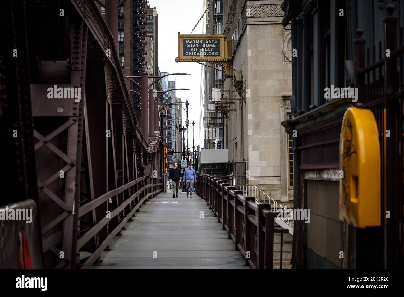 Pedestrians cross a bridge next to the Civic Opera House on Friday May ...