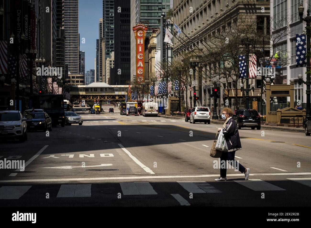 A pedestrian wearing a protective face mask crosses State Street on ...