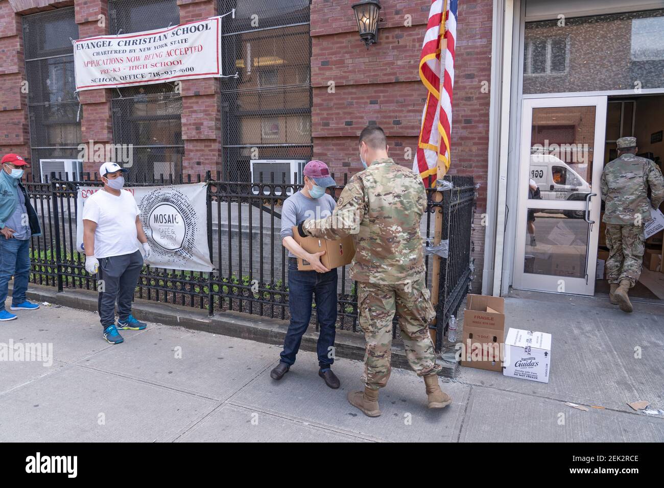 Members of the US Army National Guard hand out food and other ...