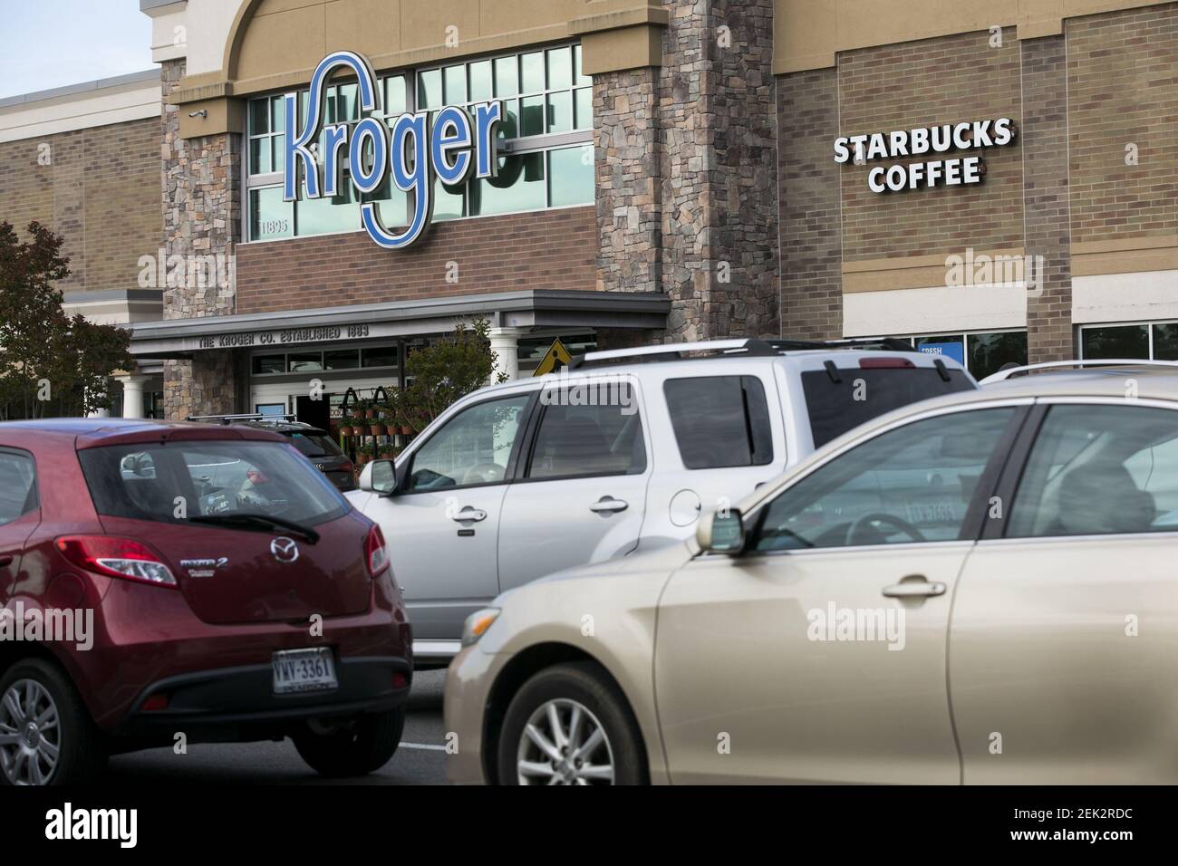 A logo sign outside of a Kroger retail grocery store location in ...