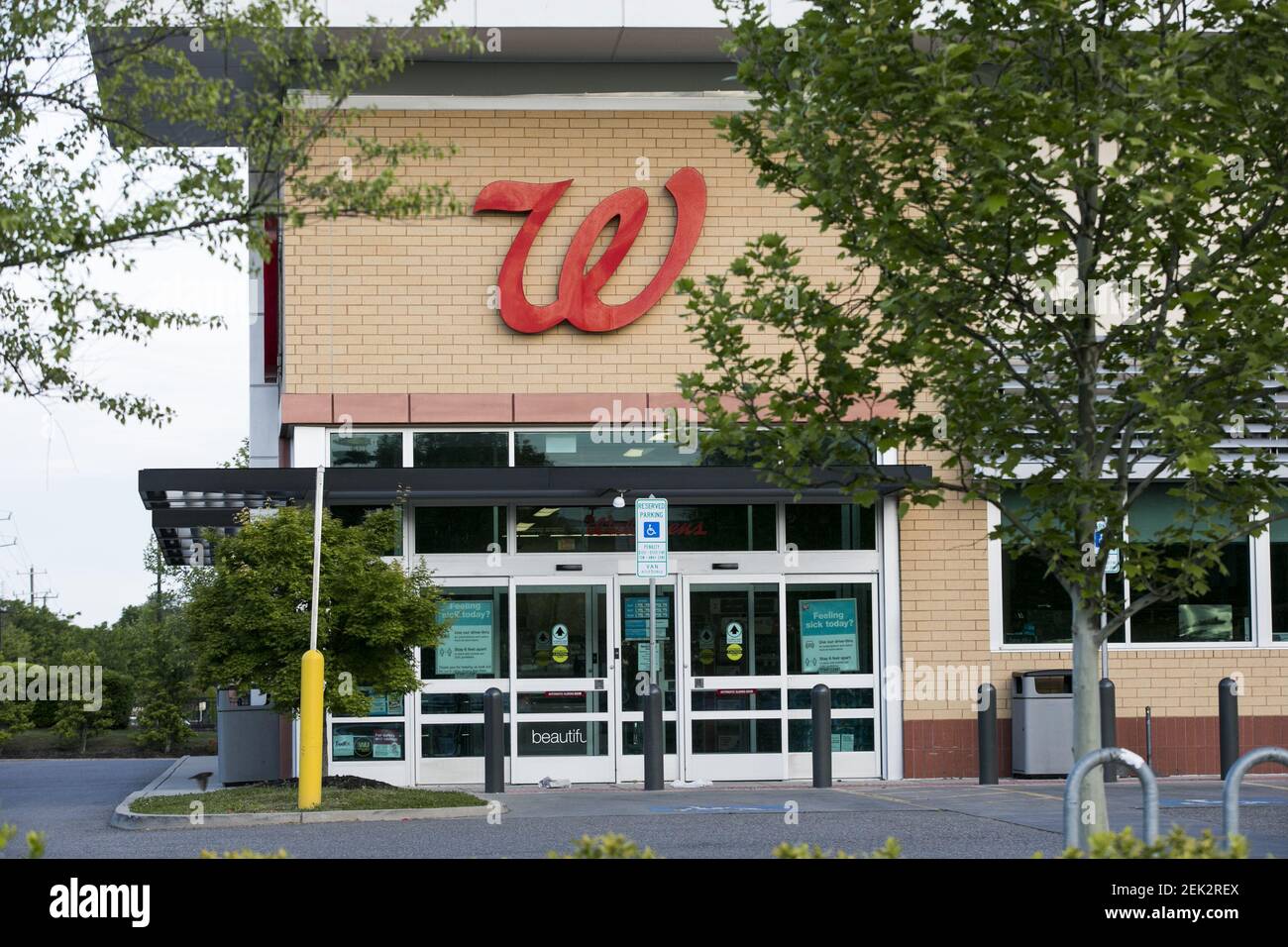 A logo sign outside of a Walgreens Pharmacy store location in Richmond ...