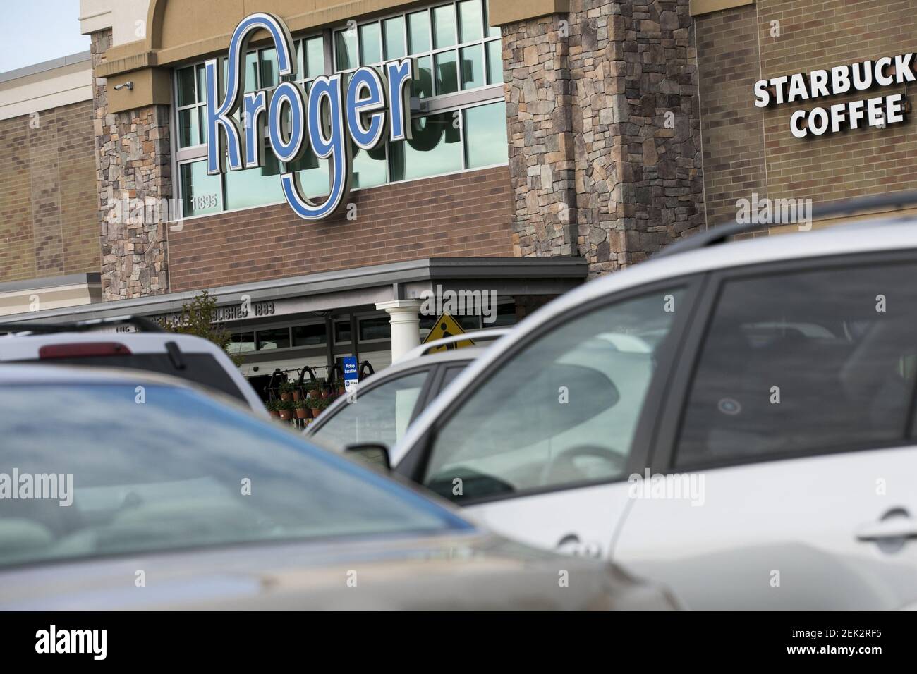 A logo sign outside of a Kroger retail grocery store location in ...
