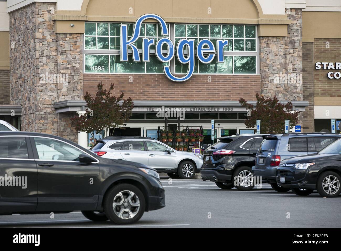 A logo sign outside of a Kroger retail grocery store location in ...