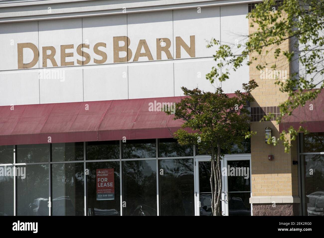 The outline of a logo sign outside of a closed and abandoned Dressbarn ...