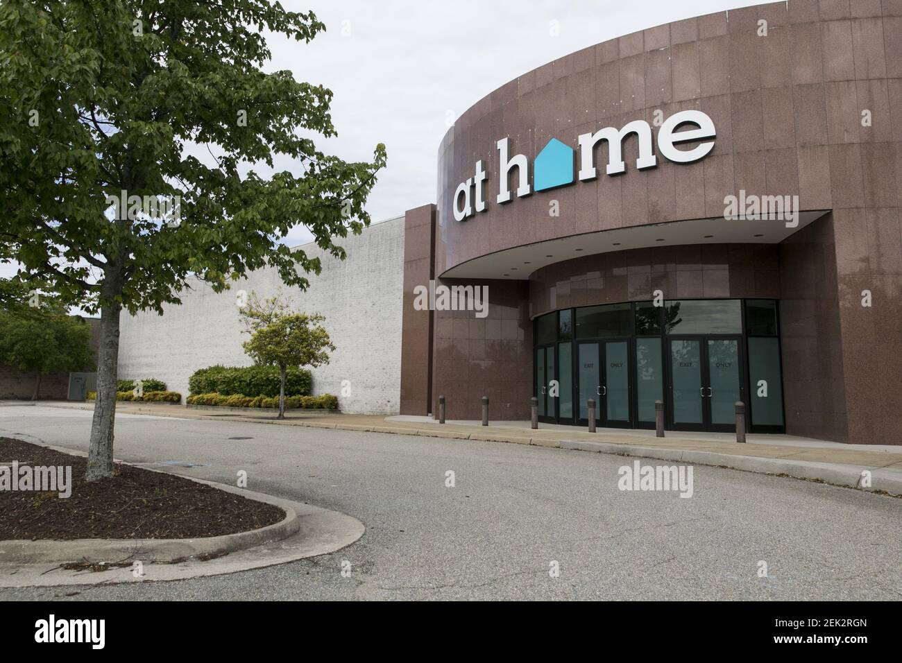 A logo sign outside of a At Home retail store location in Richmond ...