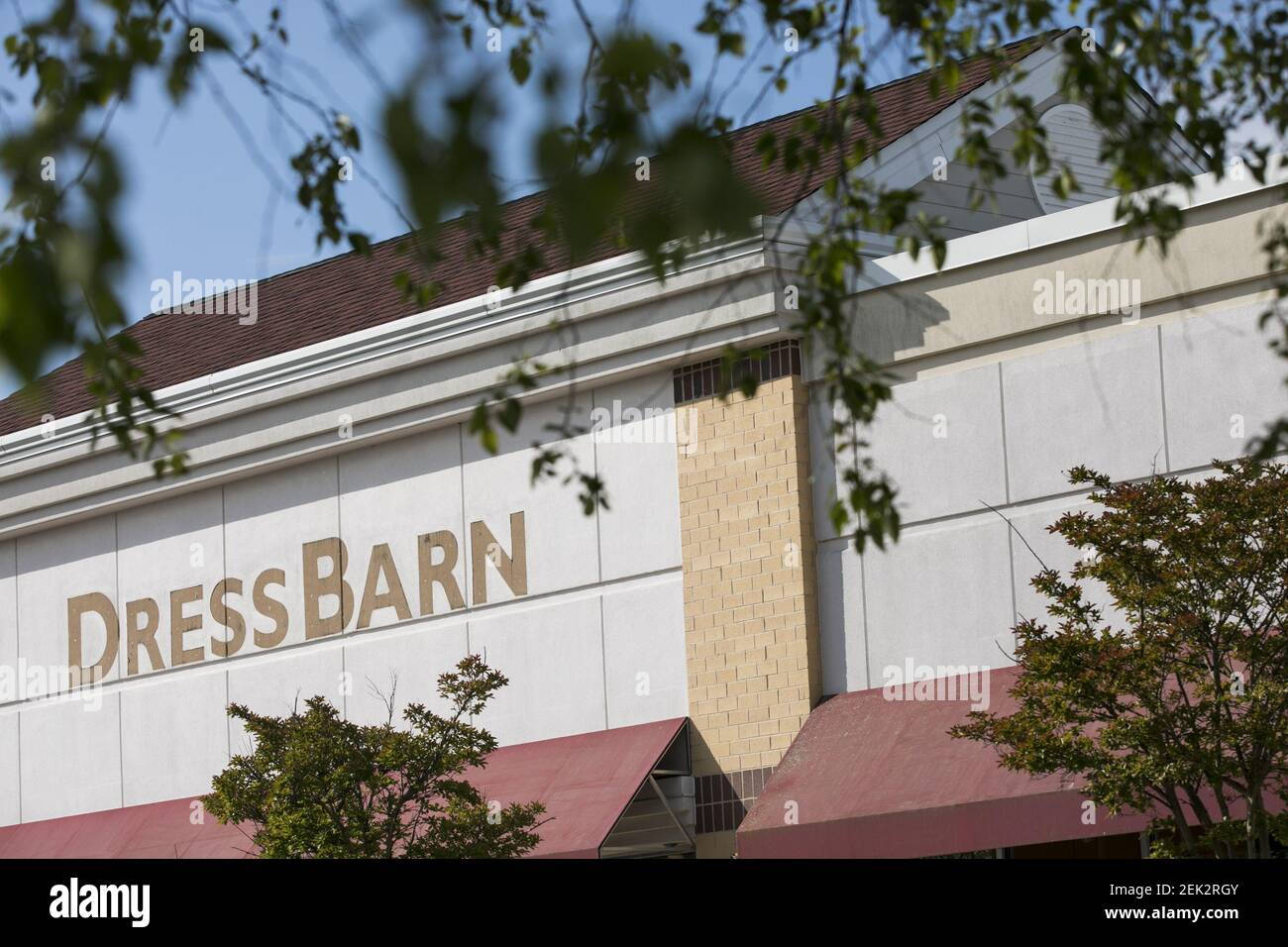 The outline of a logo sign outside of a closed and abandoned Dressbarn ...