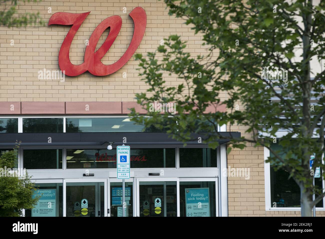 A logo sign outside of a Walgreens Pharmacy store location in Richmond ...
