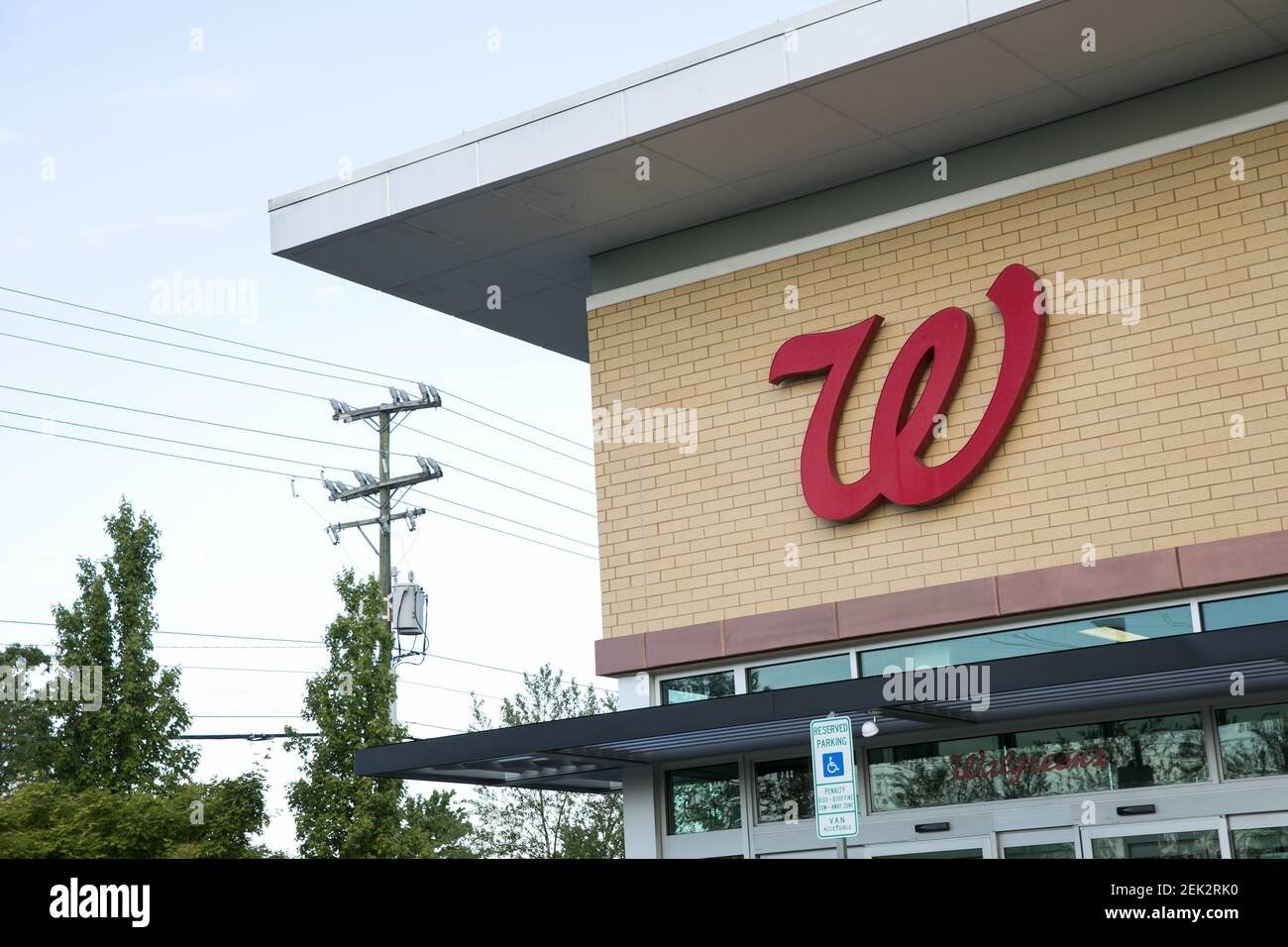 A logo sign outside of a Walgreens Pharmacy store location in Richmond ...