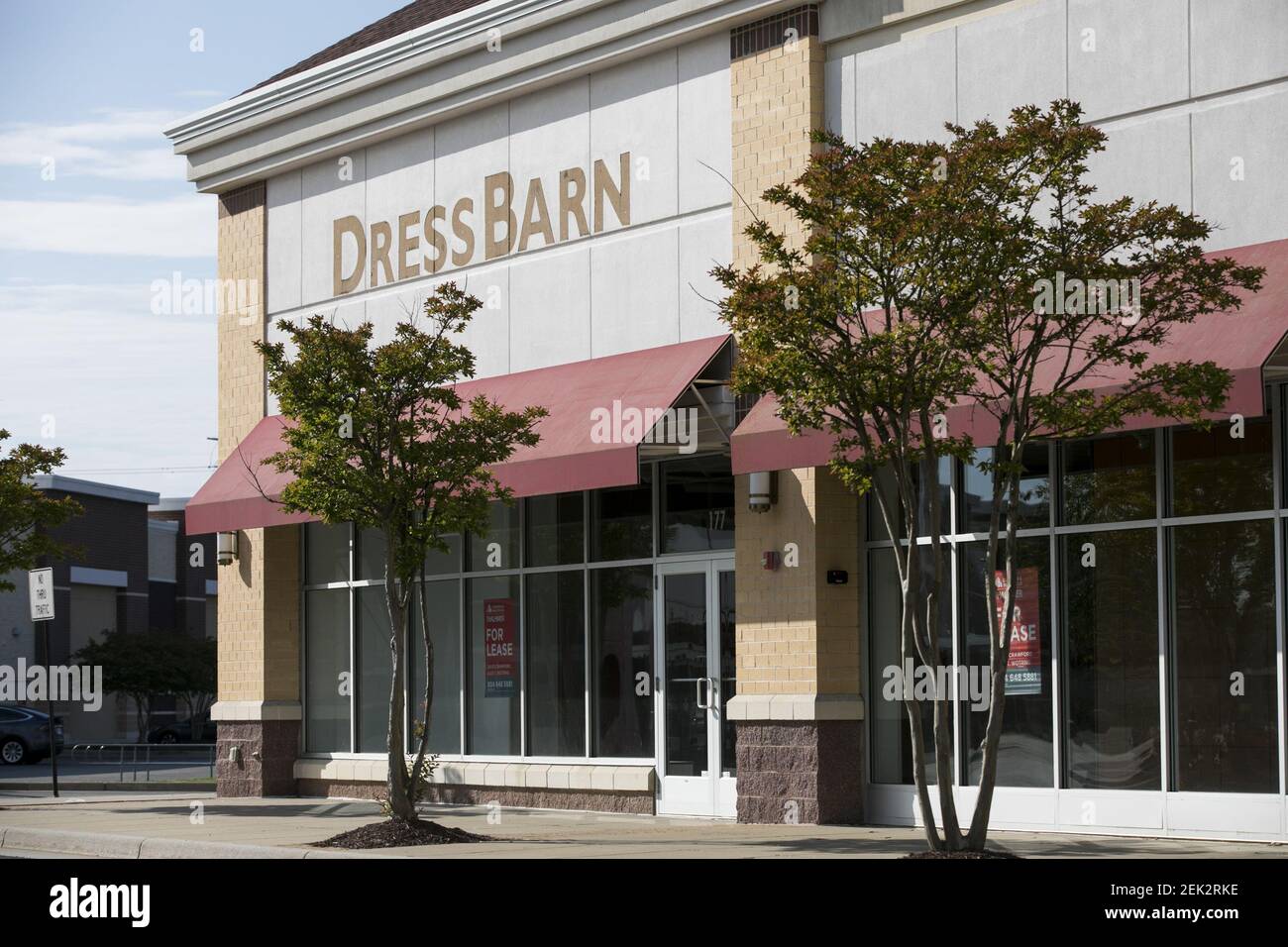 The outline of a logo sign outside of a closed and abandoned Dressbarn ...
