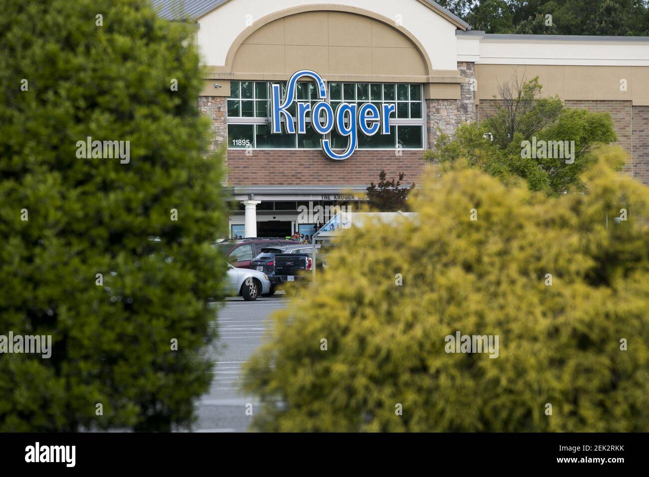 A logo sign outside of a Kroger retail grocery store location in ...