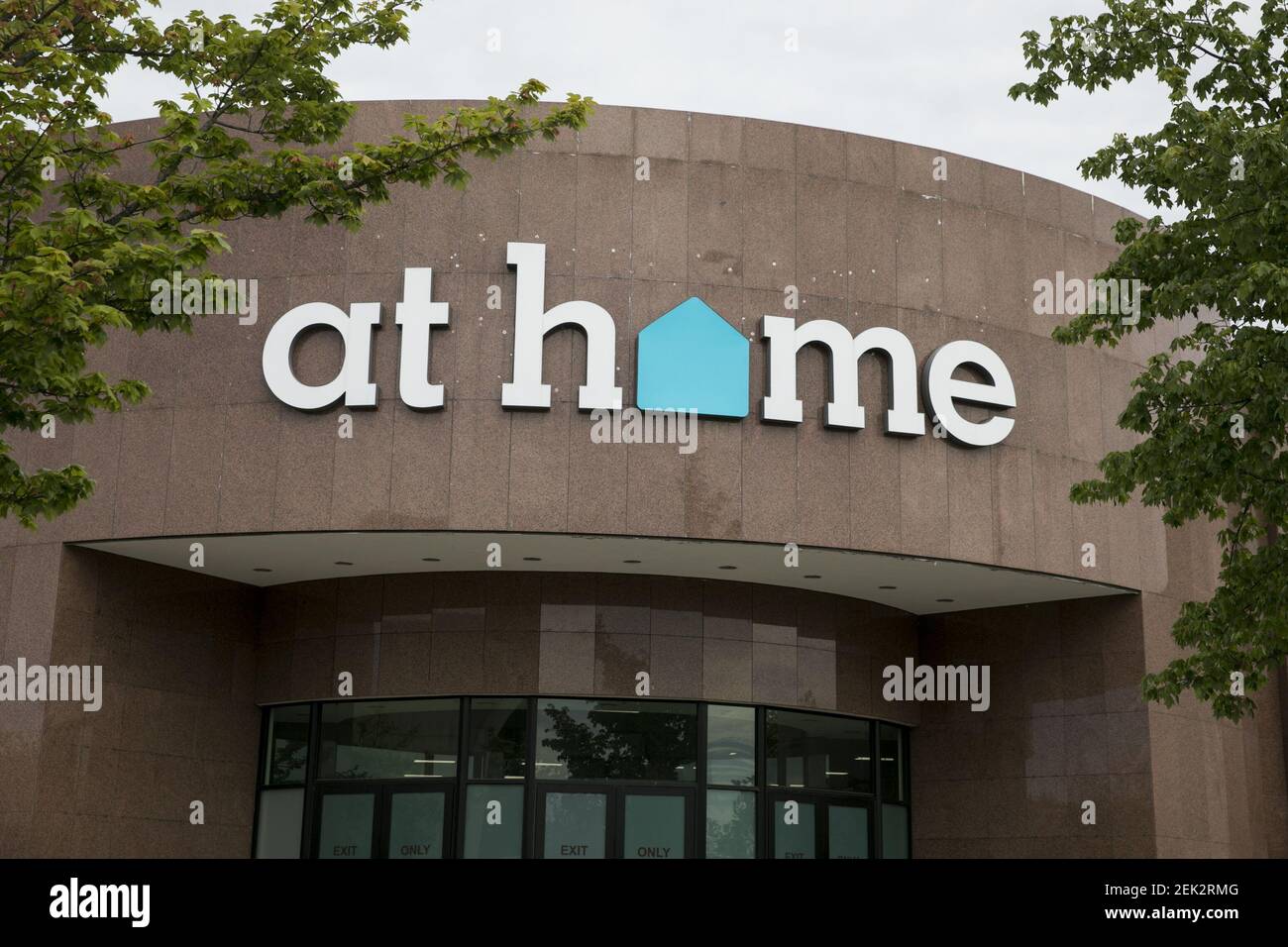 A logo sign outside of a At Home retail store location in Richmond ...