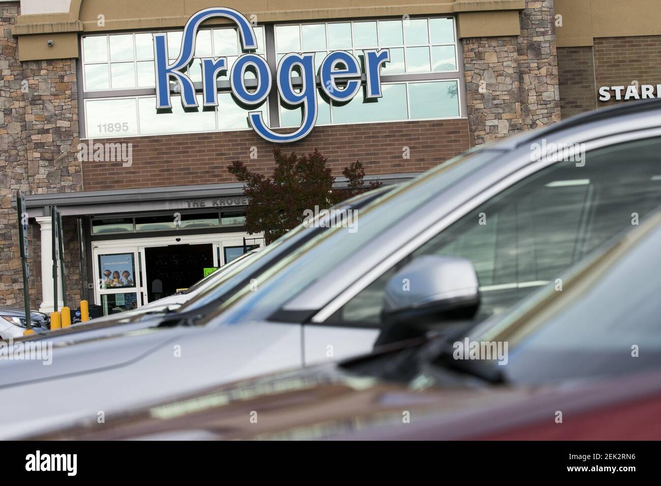 A logo sign outside of a Kroger retail grocery store location in ...