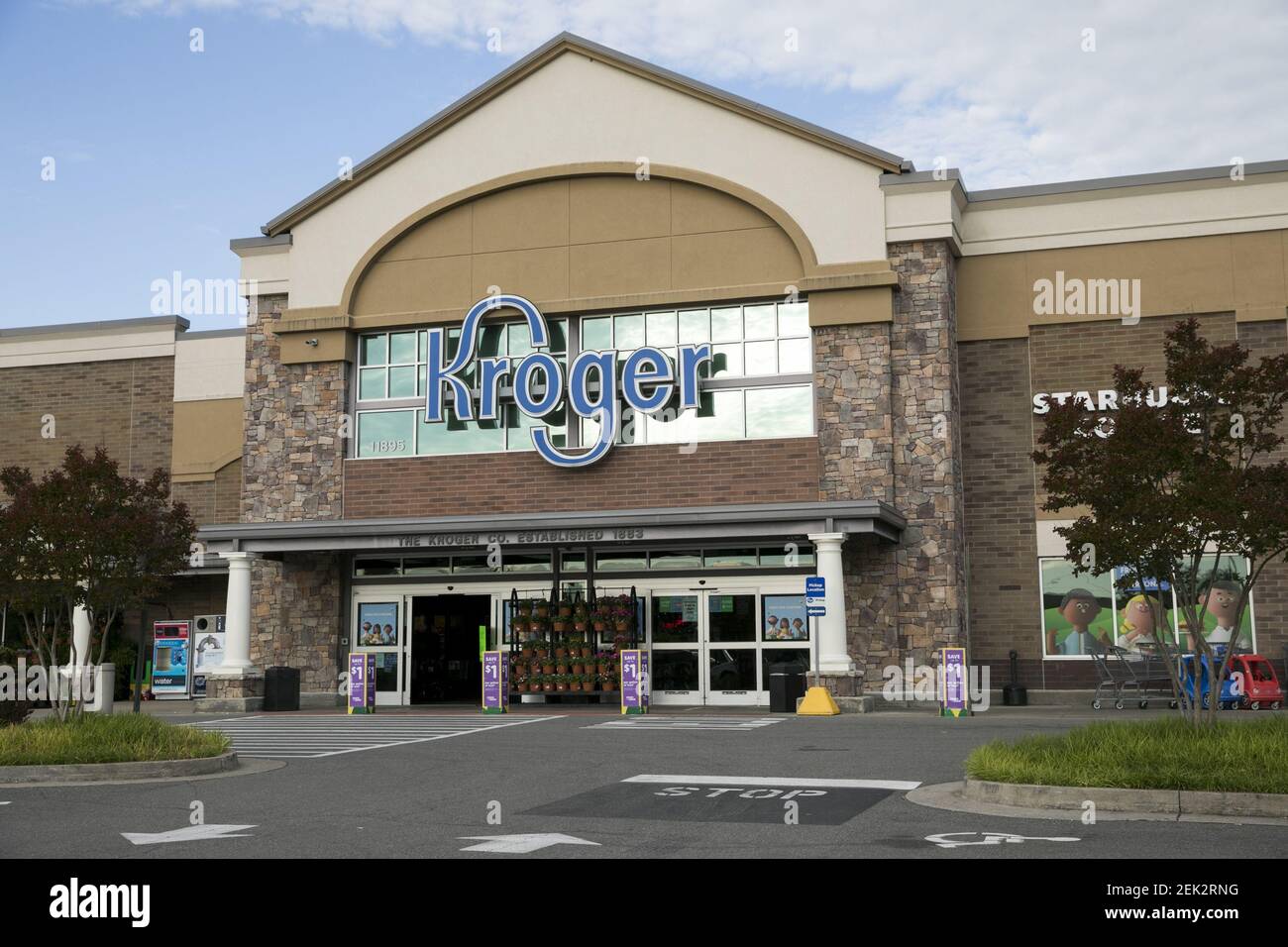 A logo sign outside of a Kroger retail grocery store location in ...