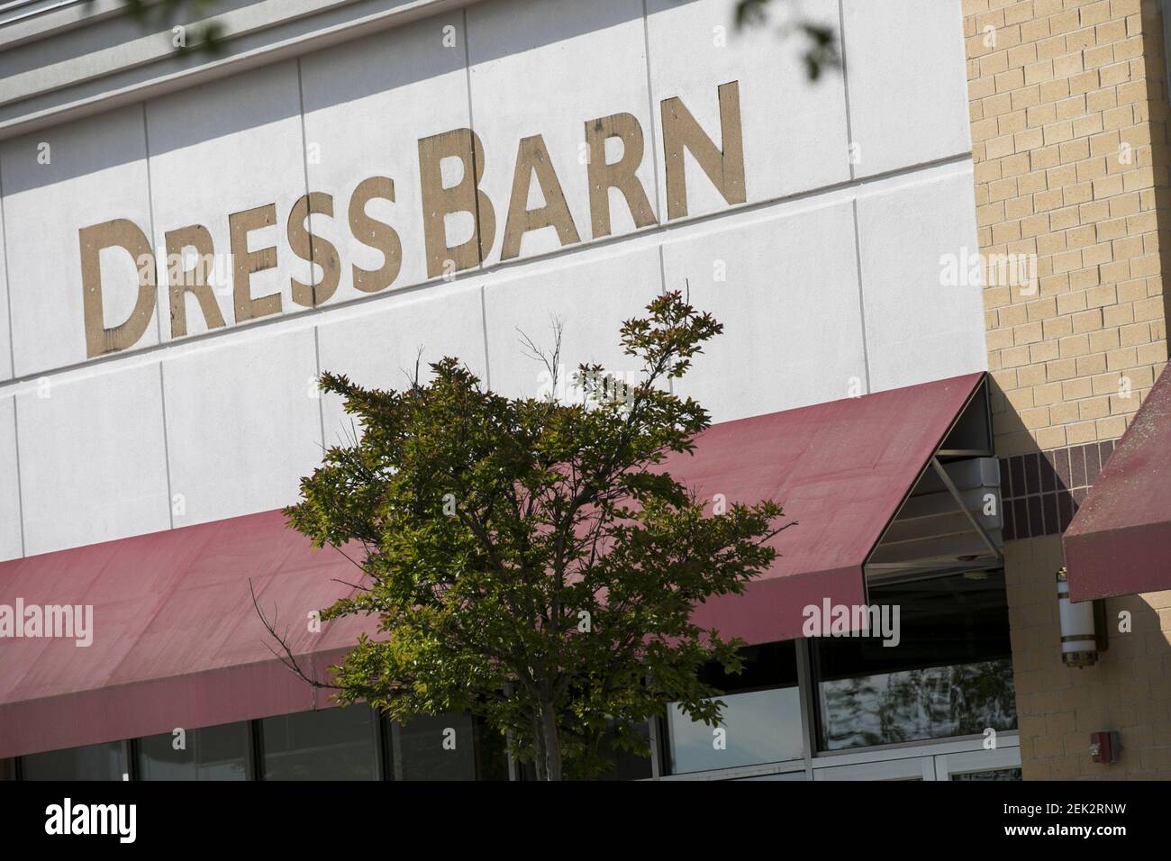 The outline of a logo sign outside of a closed and abandoned Dressbarn ...