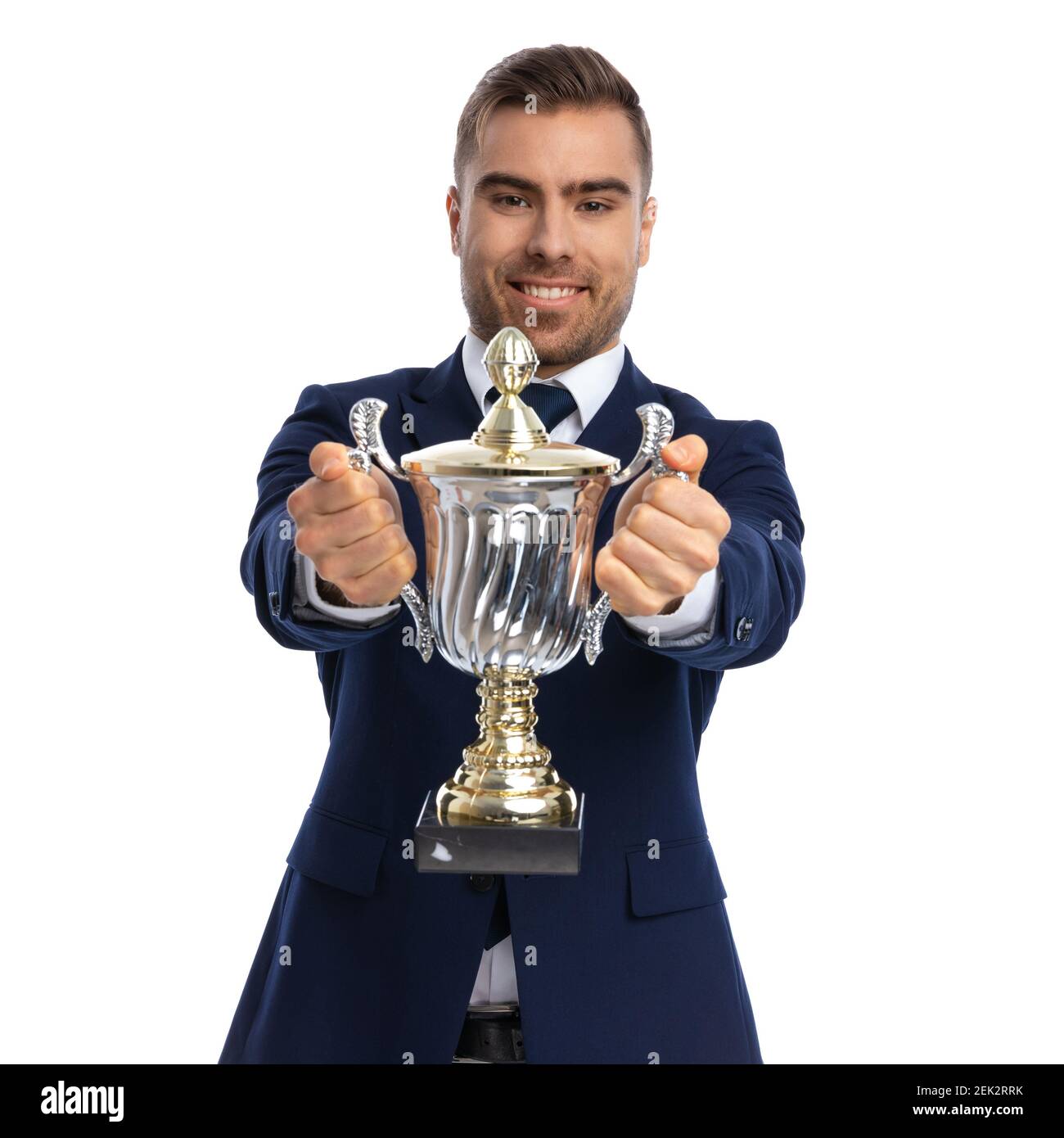 portrait of elegant fashion model in navy blue suit presenting silver ...